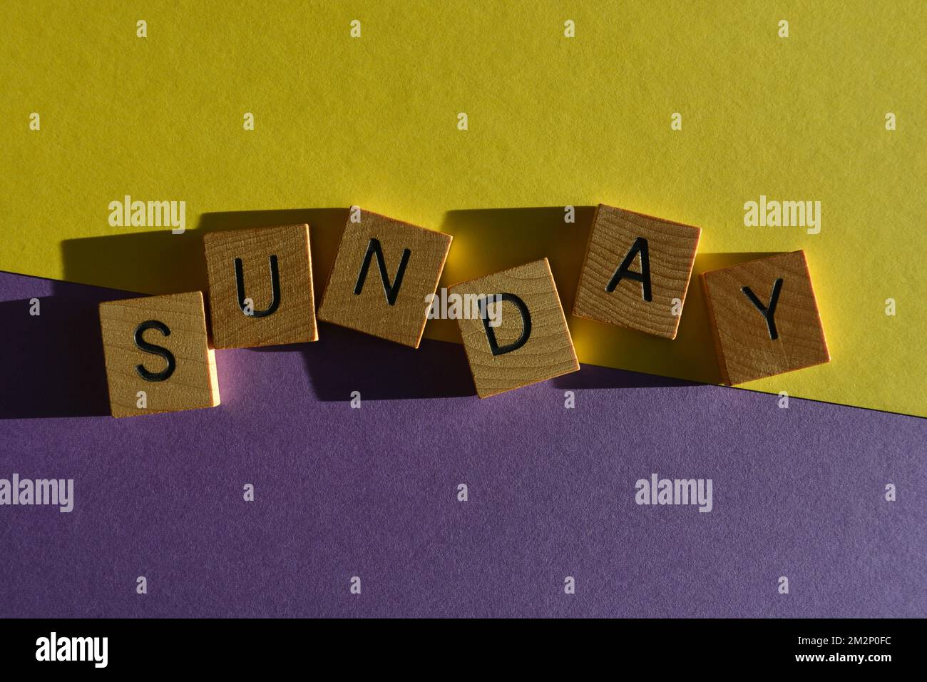 Sunday, word in wooden alphabet letters isolated on bright yellow and ...