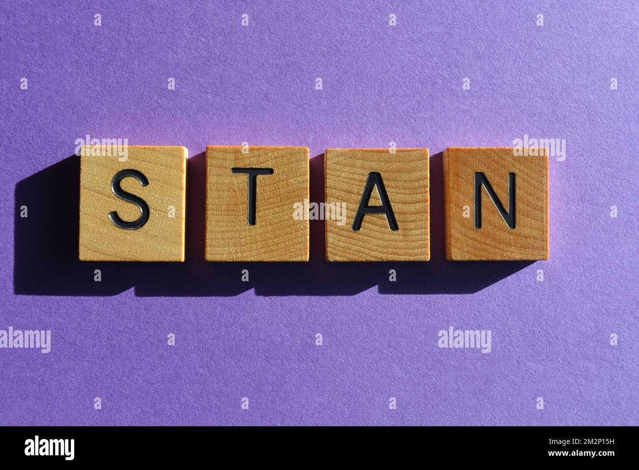 Stan, word in wooden alphabet letters isolated on purple background ...