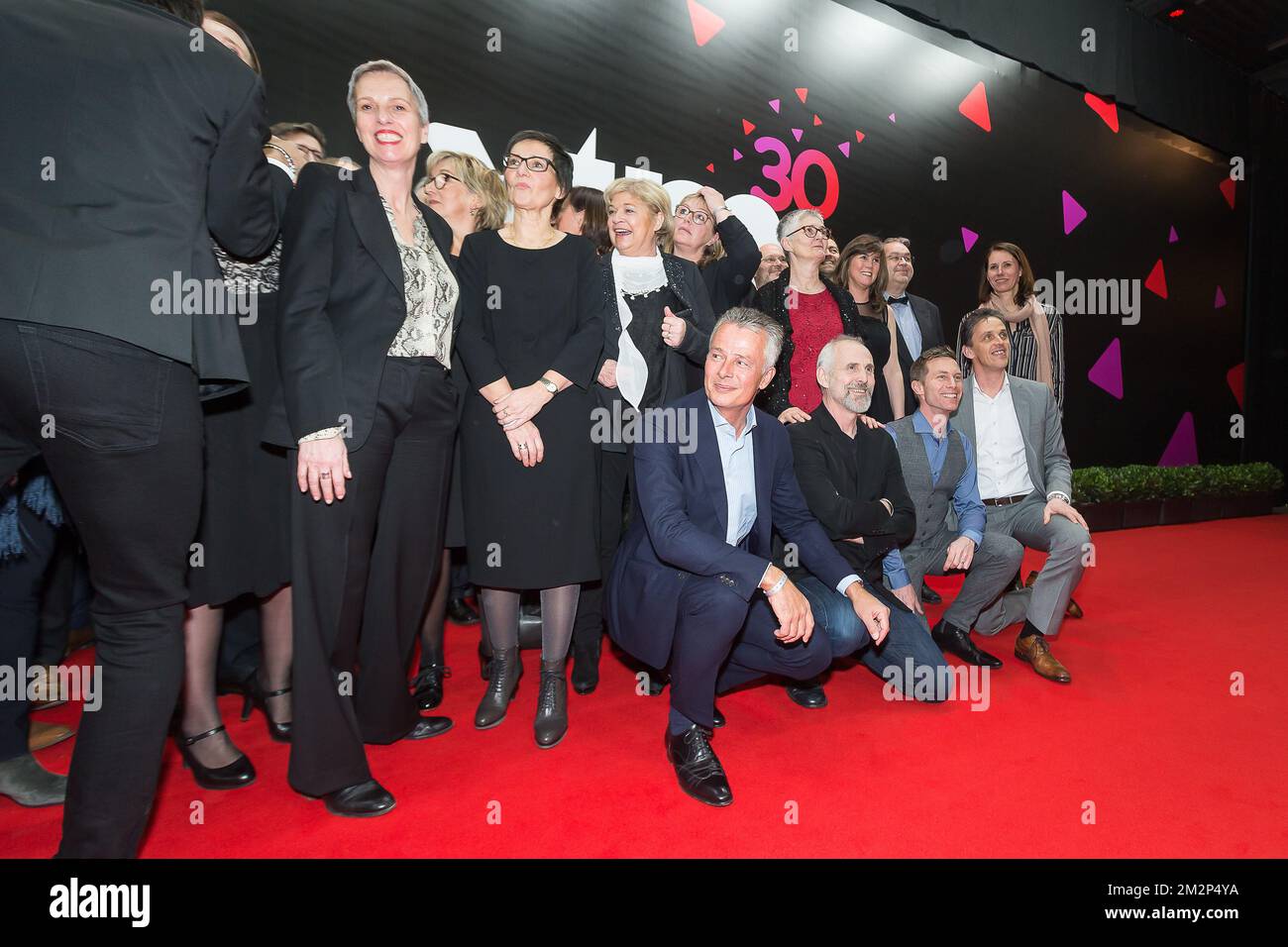 People pose for a group picture, with Christian Van Thillo in the front ...