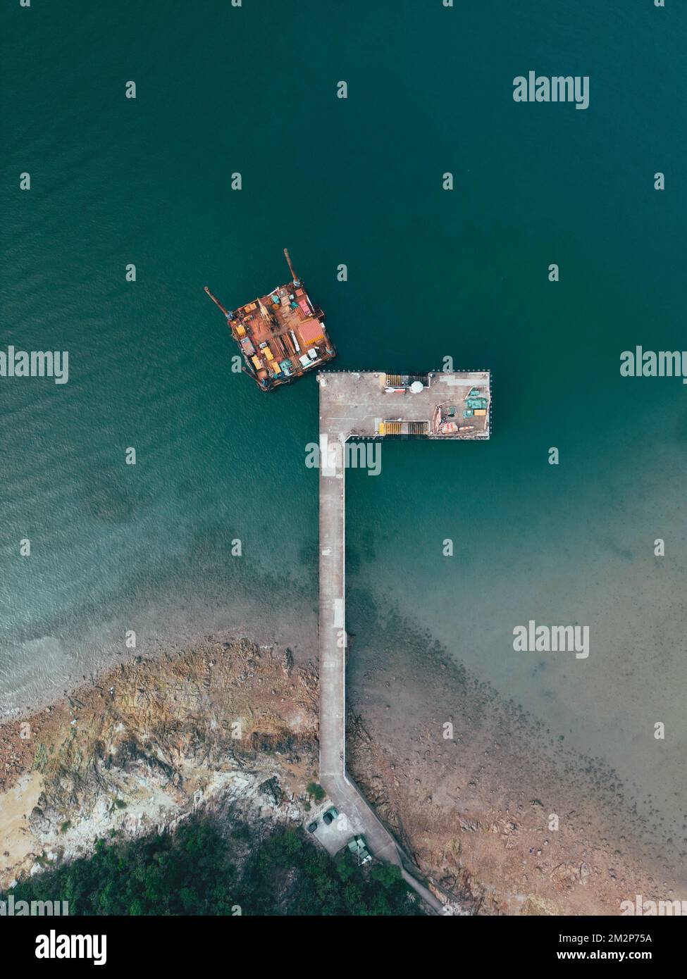 A vertical shot of a pier and shore with layered color sea Stock Photo ...