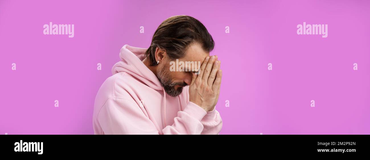 Concerned upset man supplicating asking god mercy help praying bow head ...