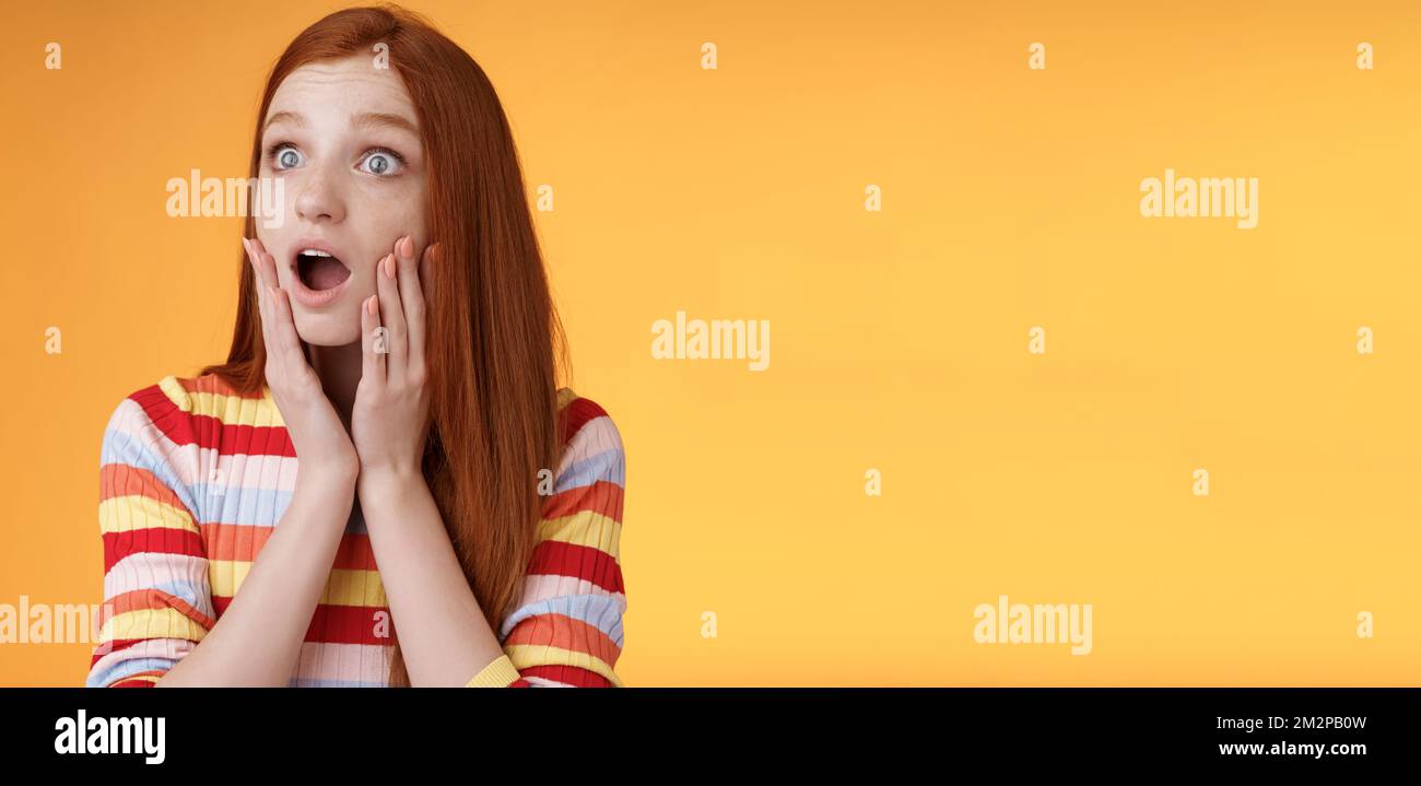 Shocked amazed young drama girl redhead blue eyes gasping empathy touch ...