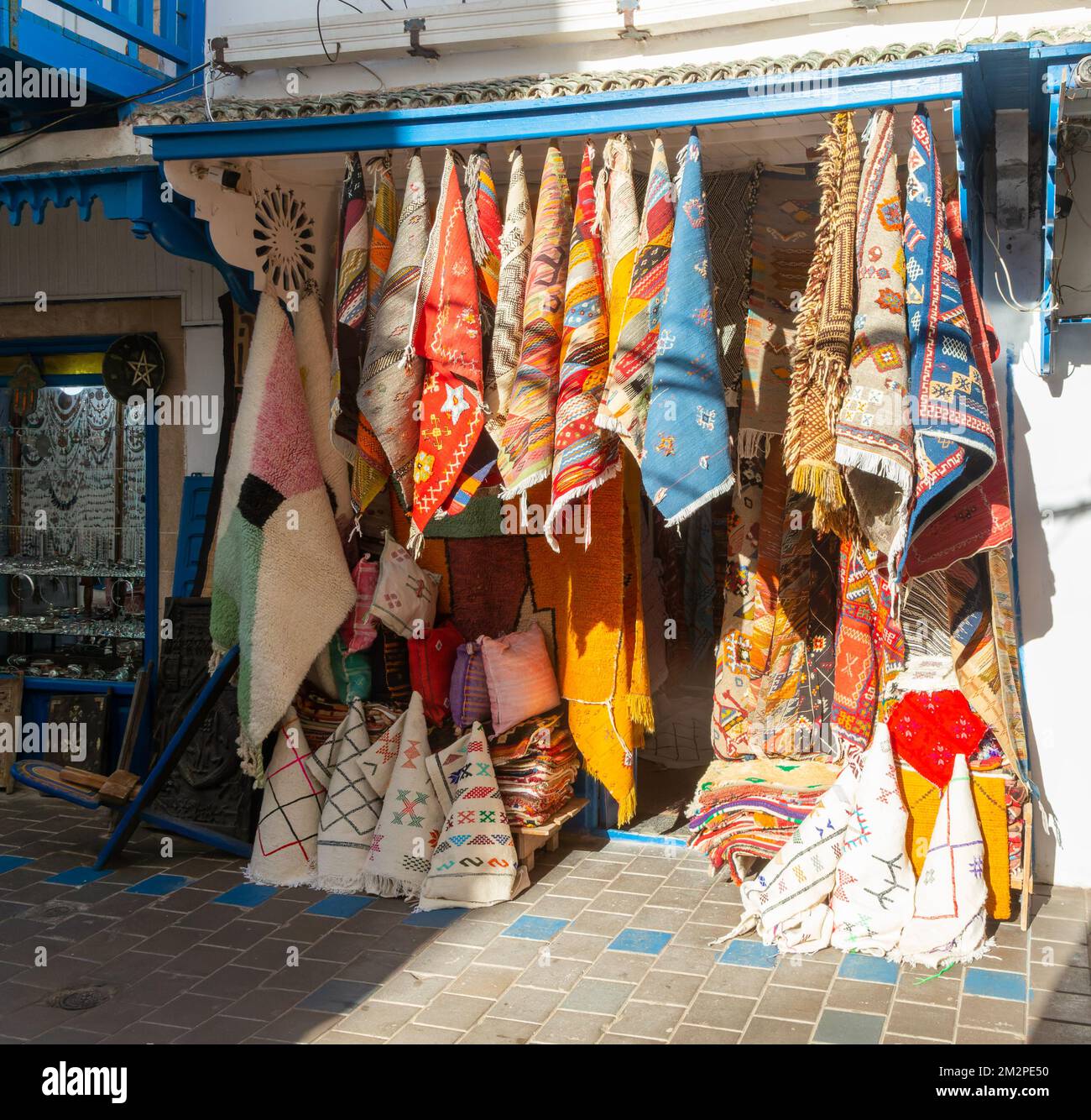 Traditional rugs hanging on display outside shop in medina area of ...