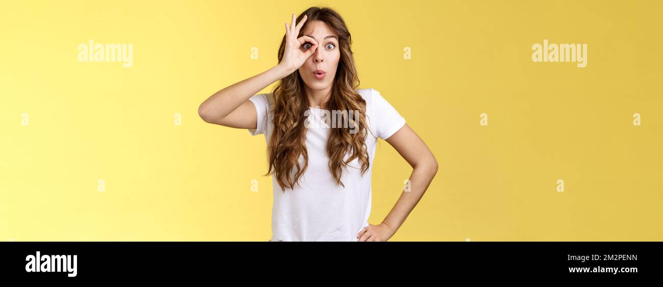 Attractive young astonished curly-haired european girl fascinated ...