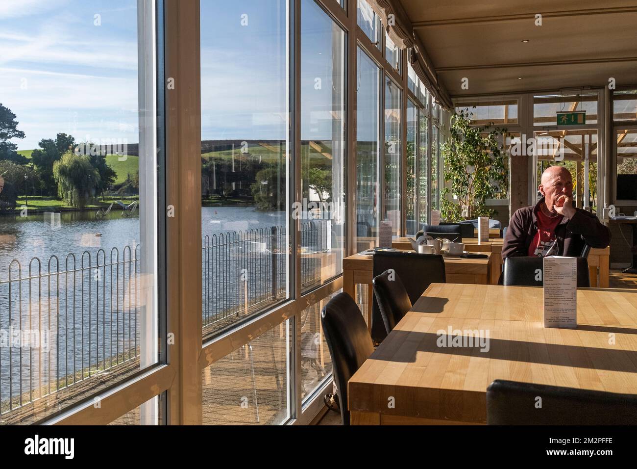 A customer sitting alone in an empty restaurant in Newquay in Cornwall ...