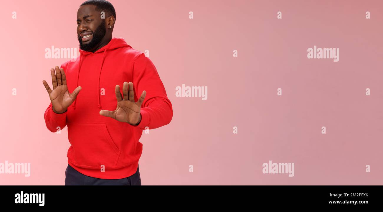 Awkward african american guy step back cringing dislike unwilling go ...