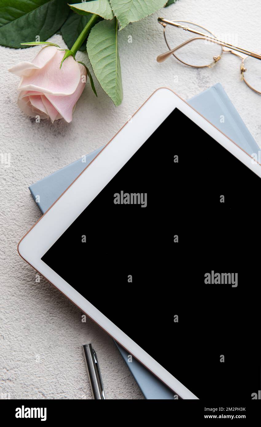 Bouquet of roses and tablet on concrete background. Top view Stock ...
