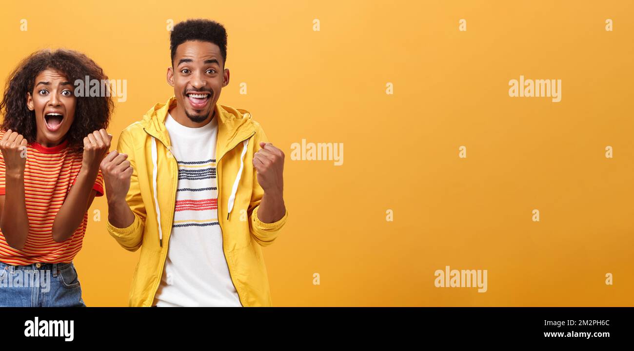 Two friends cheering and supporting mate on competition yelling ...