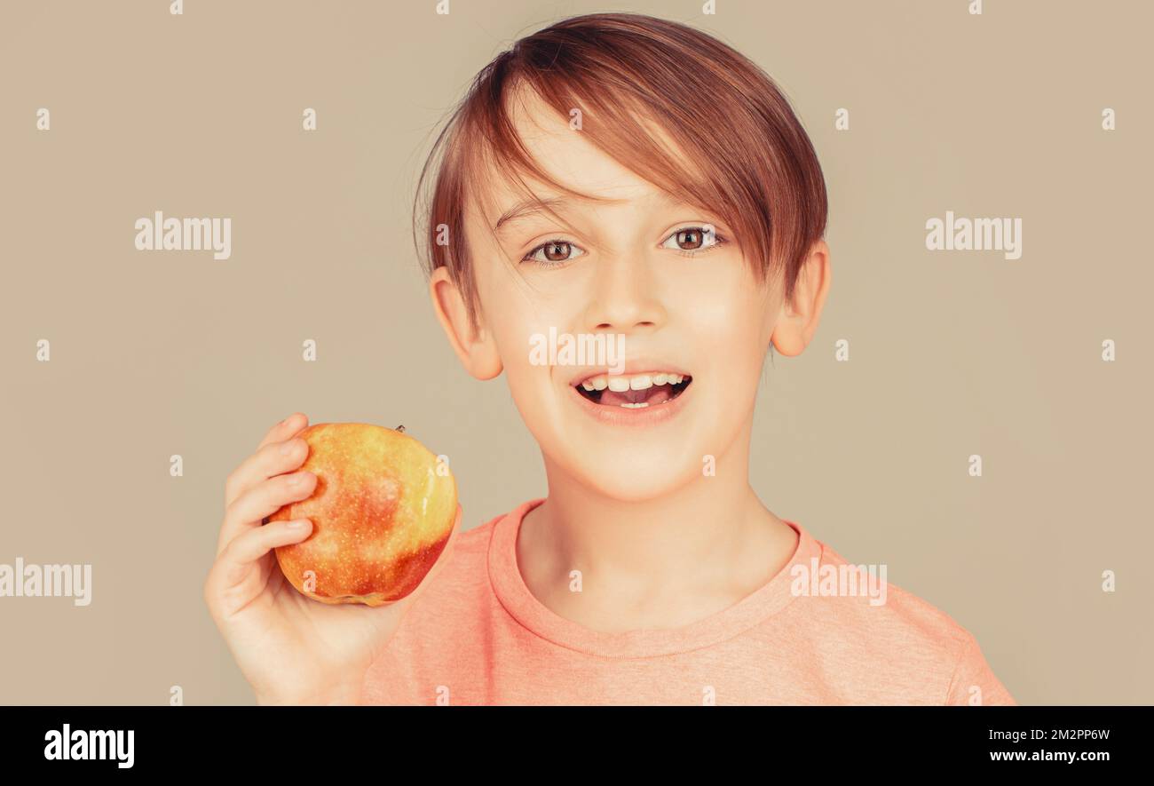 Little boy eating apple. Boy apples showing. Child with apples ...