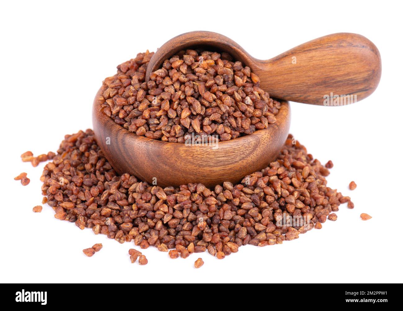 Buckwheat tea in wooden bowl and spoon, isolated on white background ...