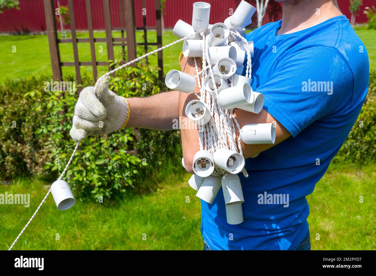 A worker is Rolling an electric cable. House cleanup in the open air ...
