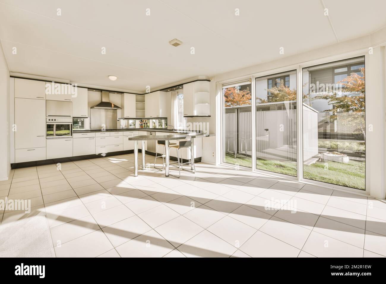 a kitchen and dining area in a house with sliding glass doors that open ...