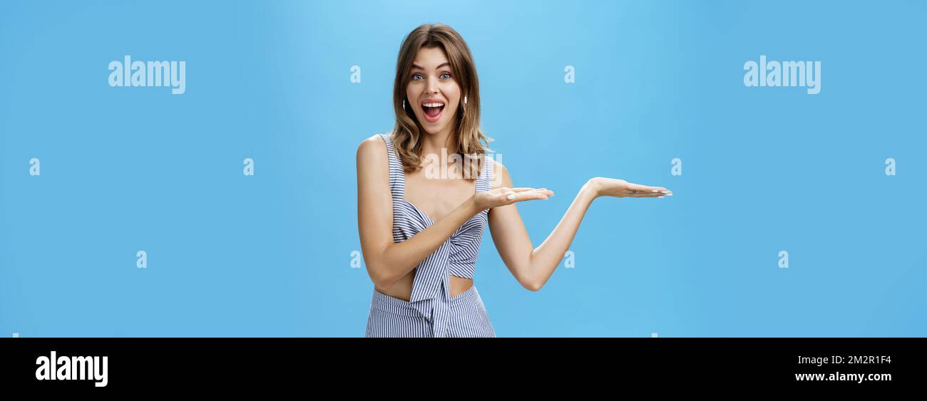 Woman presenting product over copy space. Good-looking charismatic ...