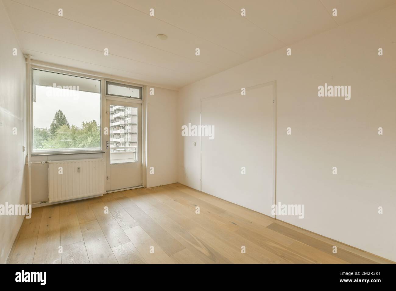 an empty room with wood flooring and white paint on the walls there is ...