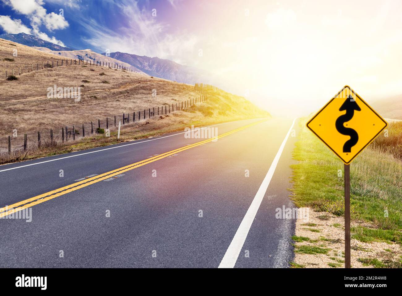 Asphalt road, road sign and country landscape with sunny sky ...