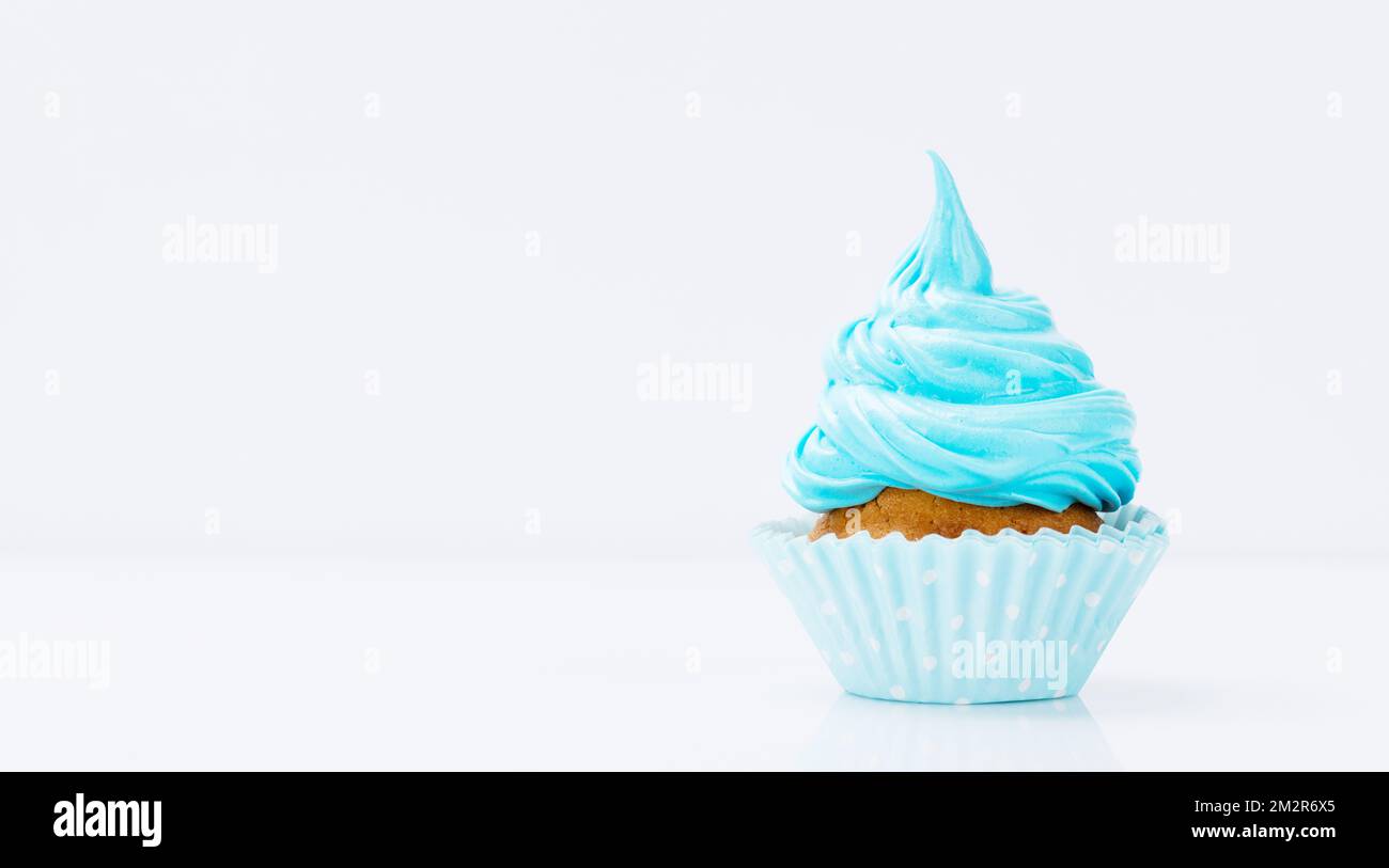 Blue cupcake on grey background with copy space Stock Photo - Alamy