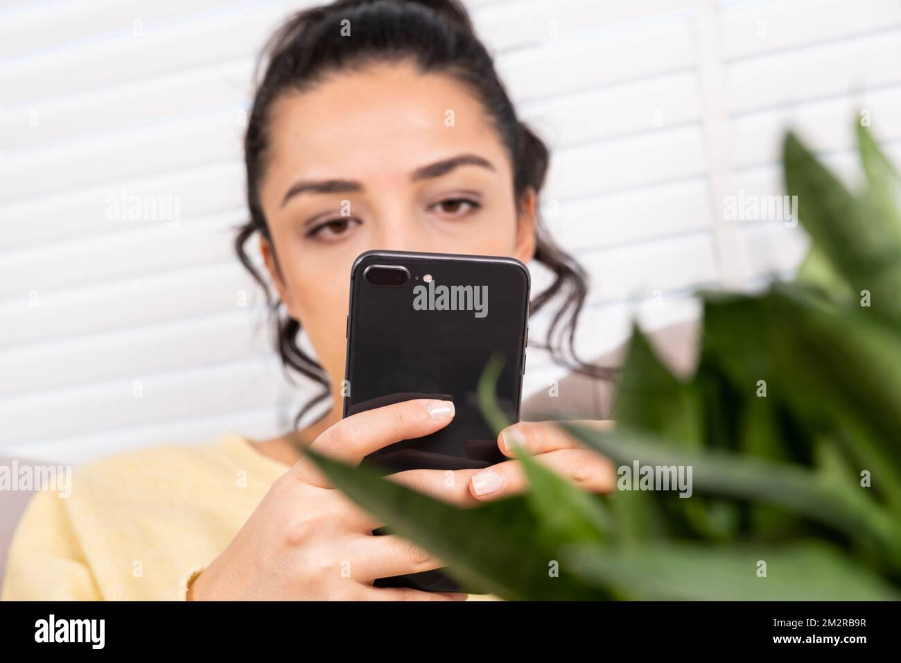 Using smartphone, portrait of women using smartphone. Holding front of ...