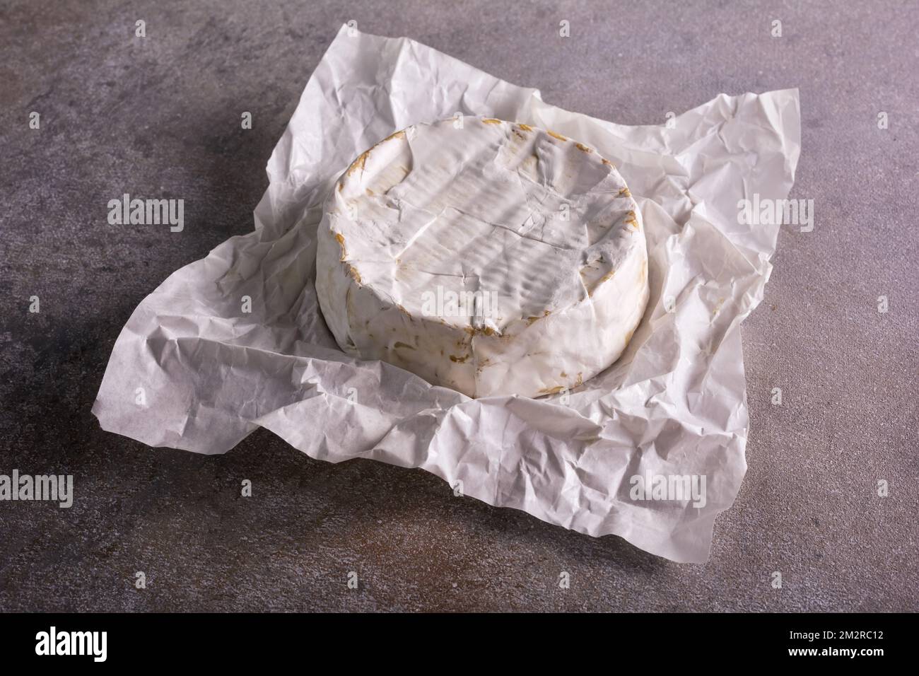 White brie cheese or camembert, tasty meal for baking on grey concrete ...