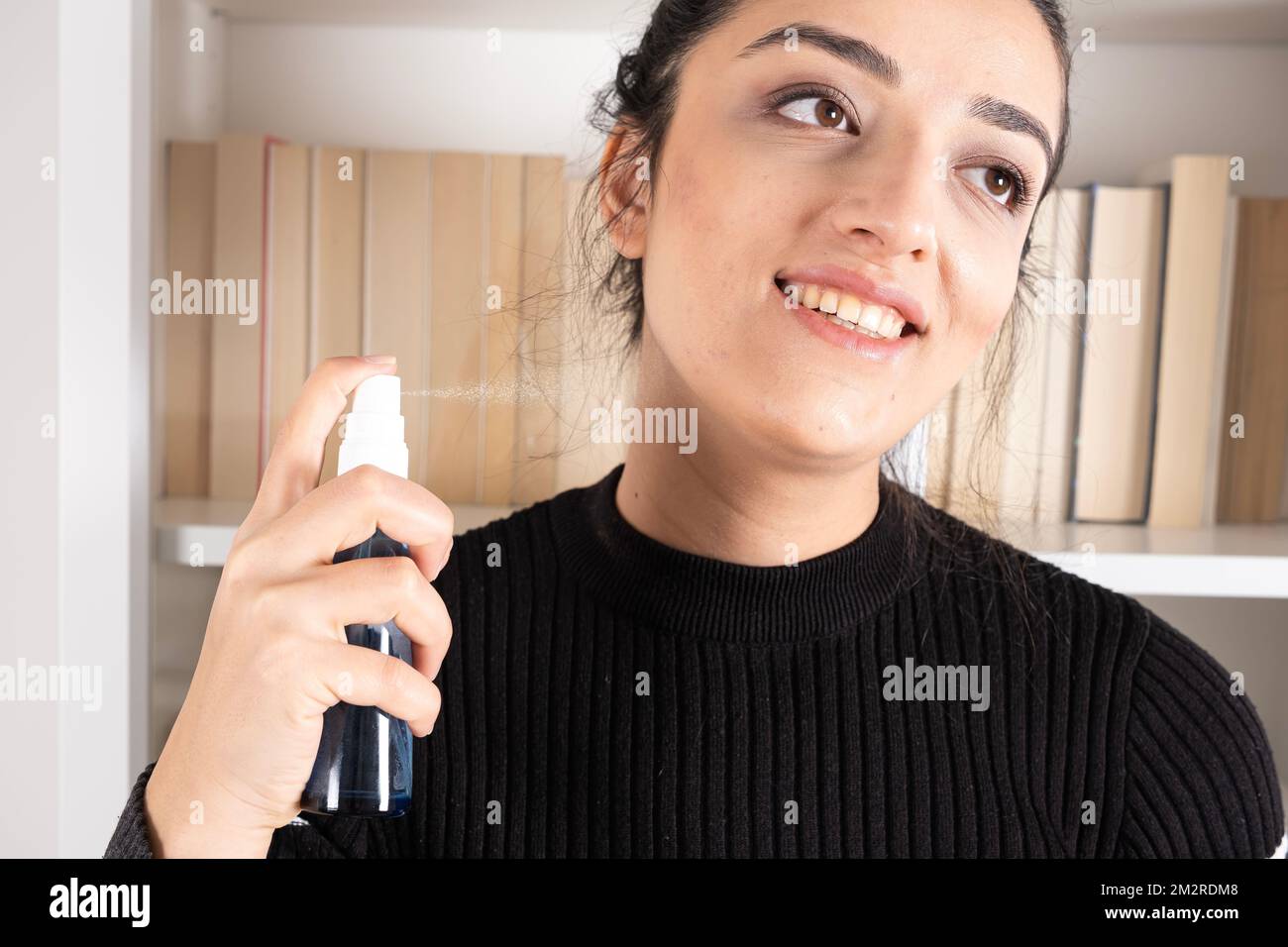 Using perfume, beautiful brunette woman using perfume. Holding and ...