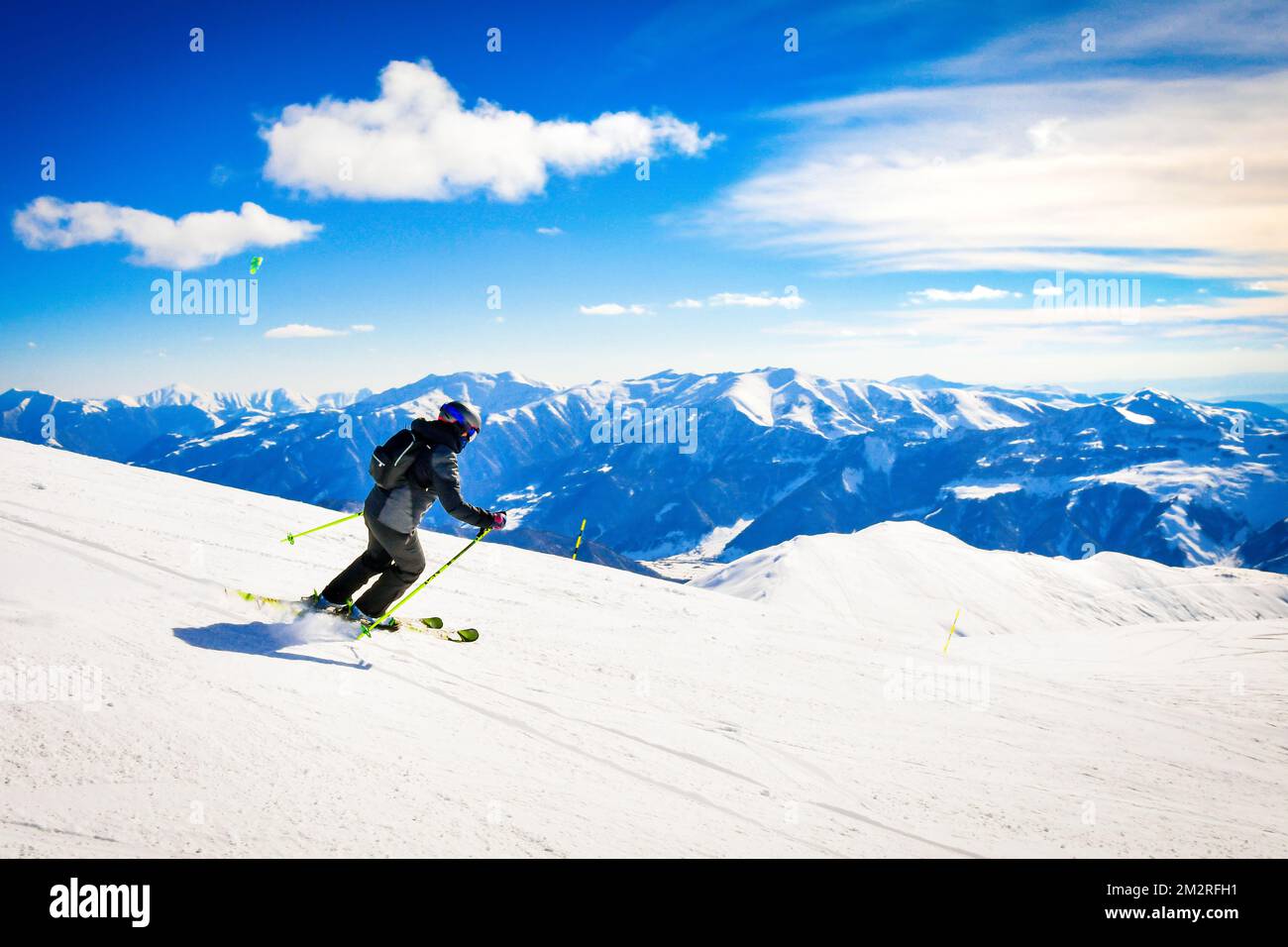 Male skier skiing downhill fast pass side view to gondola with ...