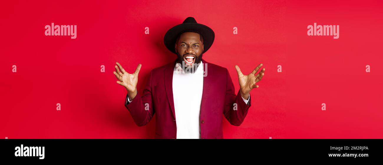 Angry Black man screaming and shaking hands with hatred, losing temper ...