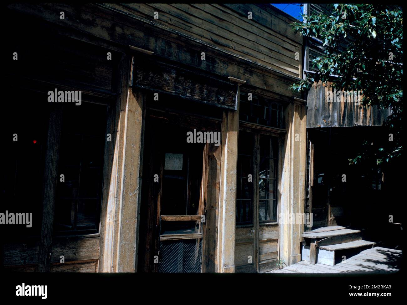 Entrance to wooden building with sign on door 'Gone to dinner,' Nevada ...