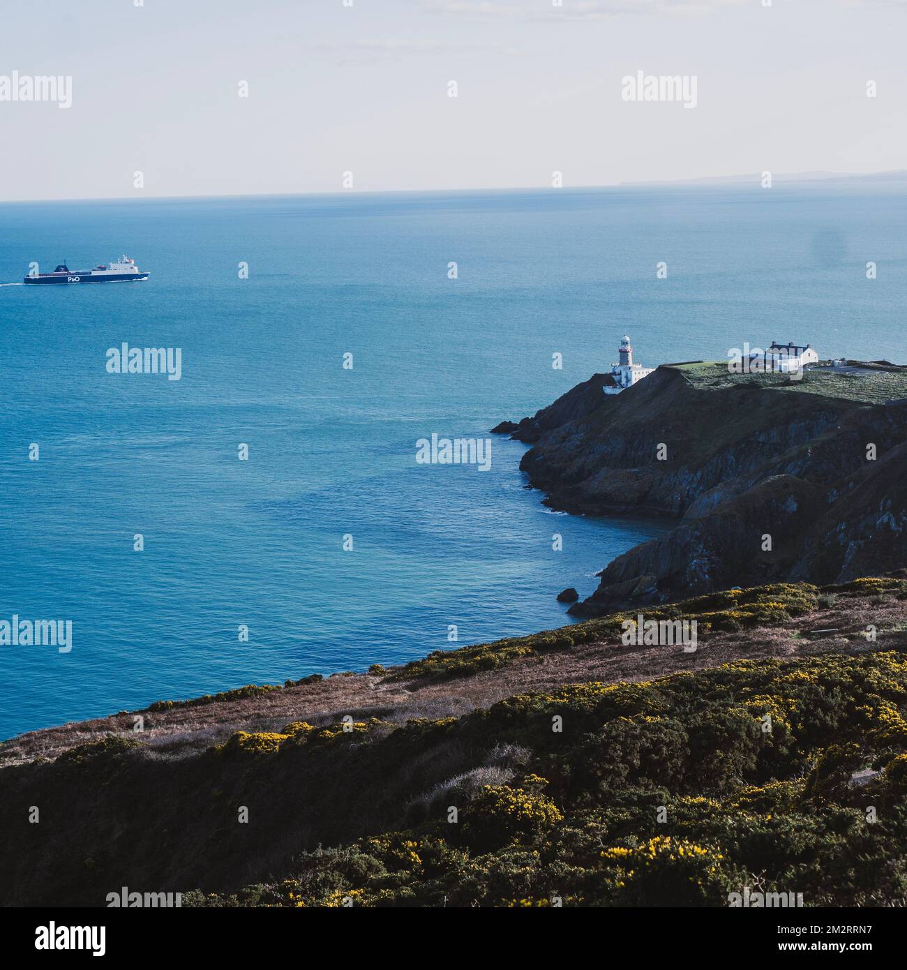 An aerial view of Howth Head peninsula with Baily Lighthouse and ship ...