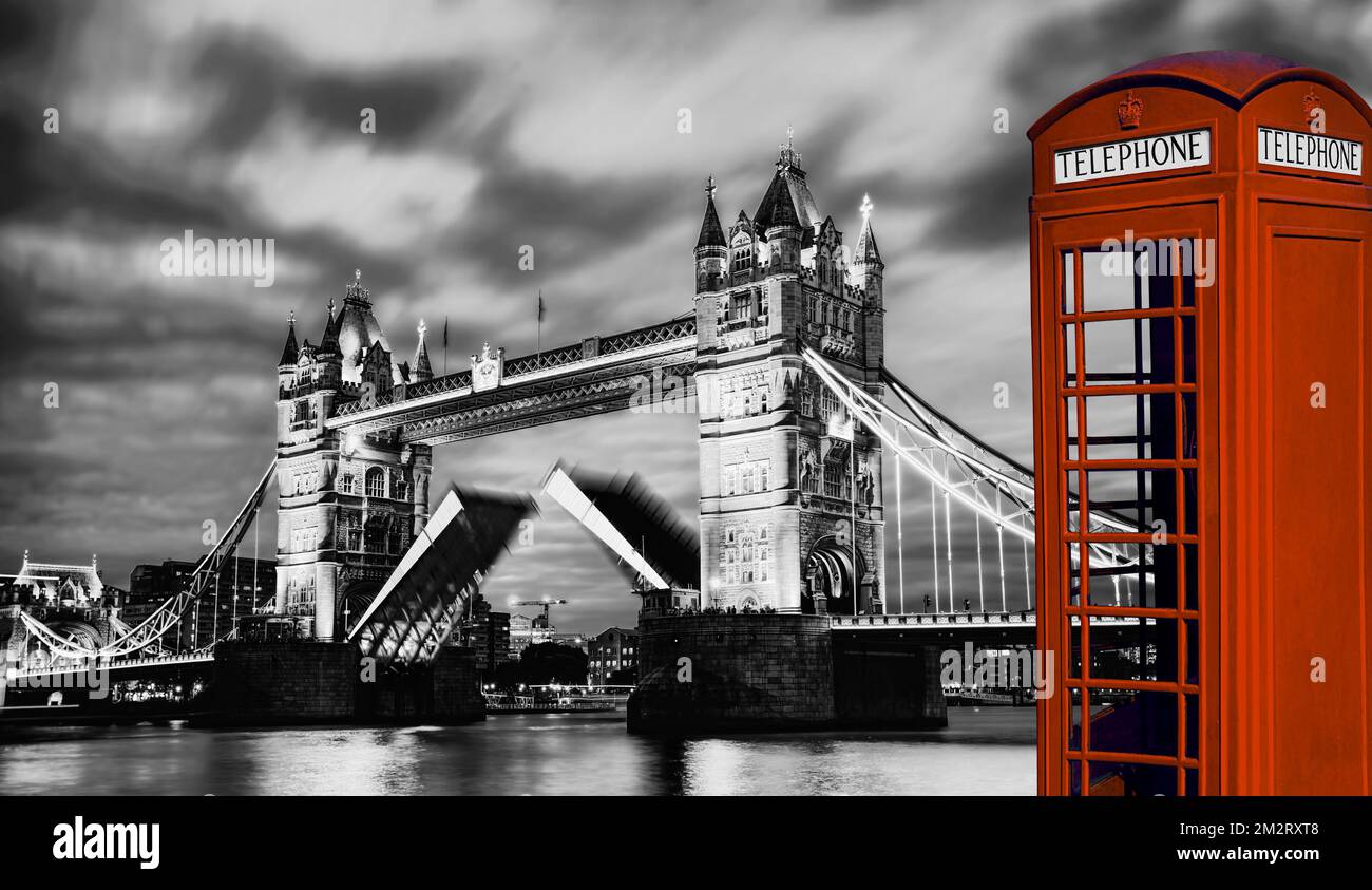 Tower Bridge lift time against red phone booth in London, England, UK ...