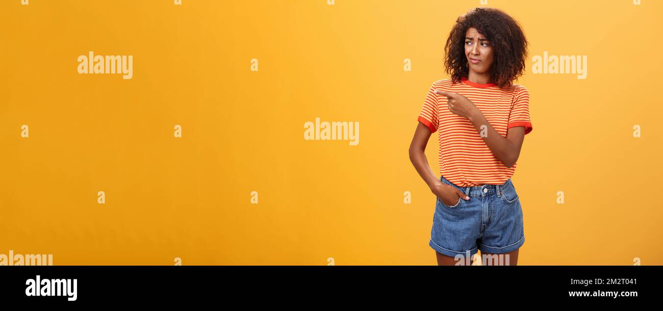 Girl looking at doubtful unimpressive perfomance of model. Portrait of ...