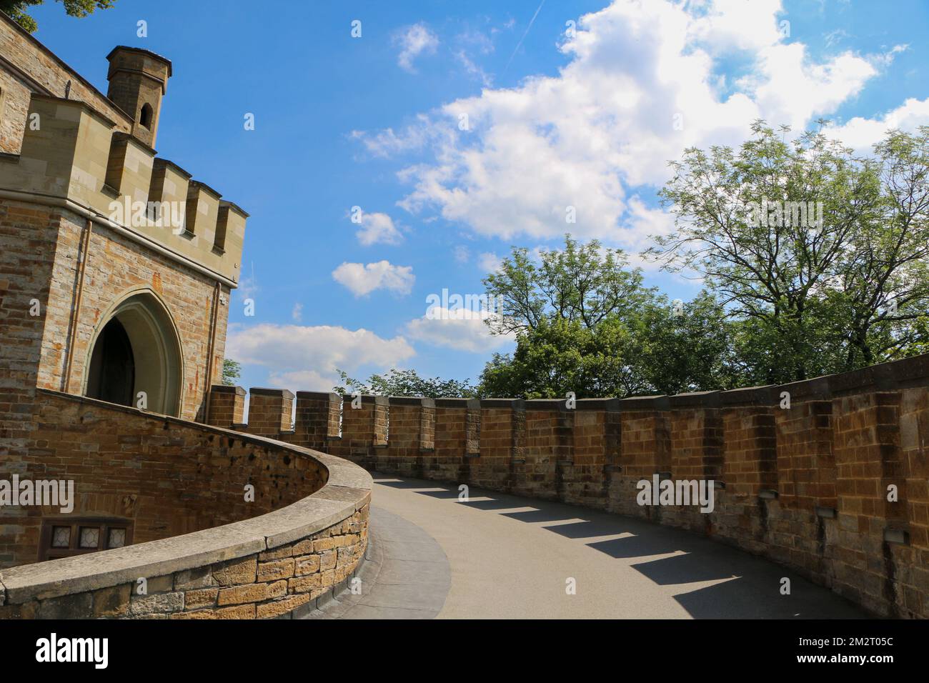 The walkway leading to the gate of Hohenzollern Castle on a sunny day ...