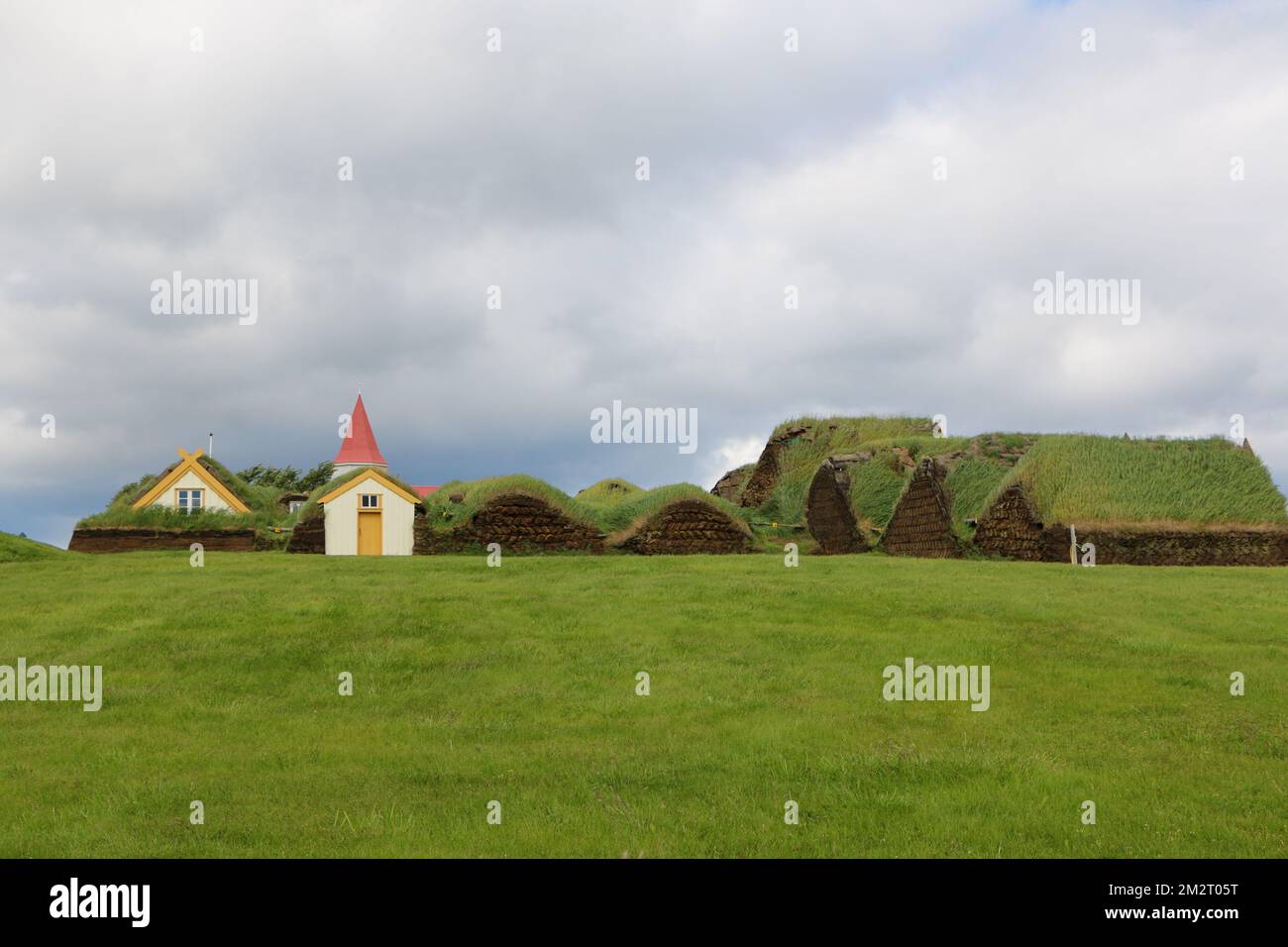 The historic turf houses in Glaumbaer farm in under overcast sky in ...