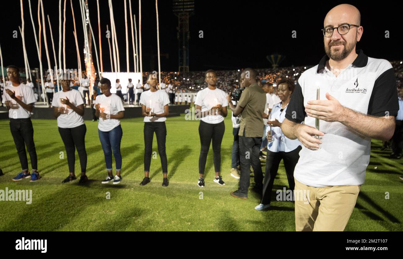 Belgian Prime Minister Charles Michel holds a candle during a vigil ...