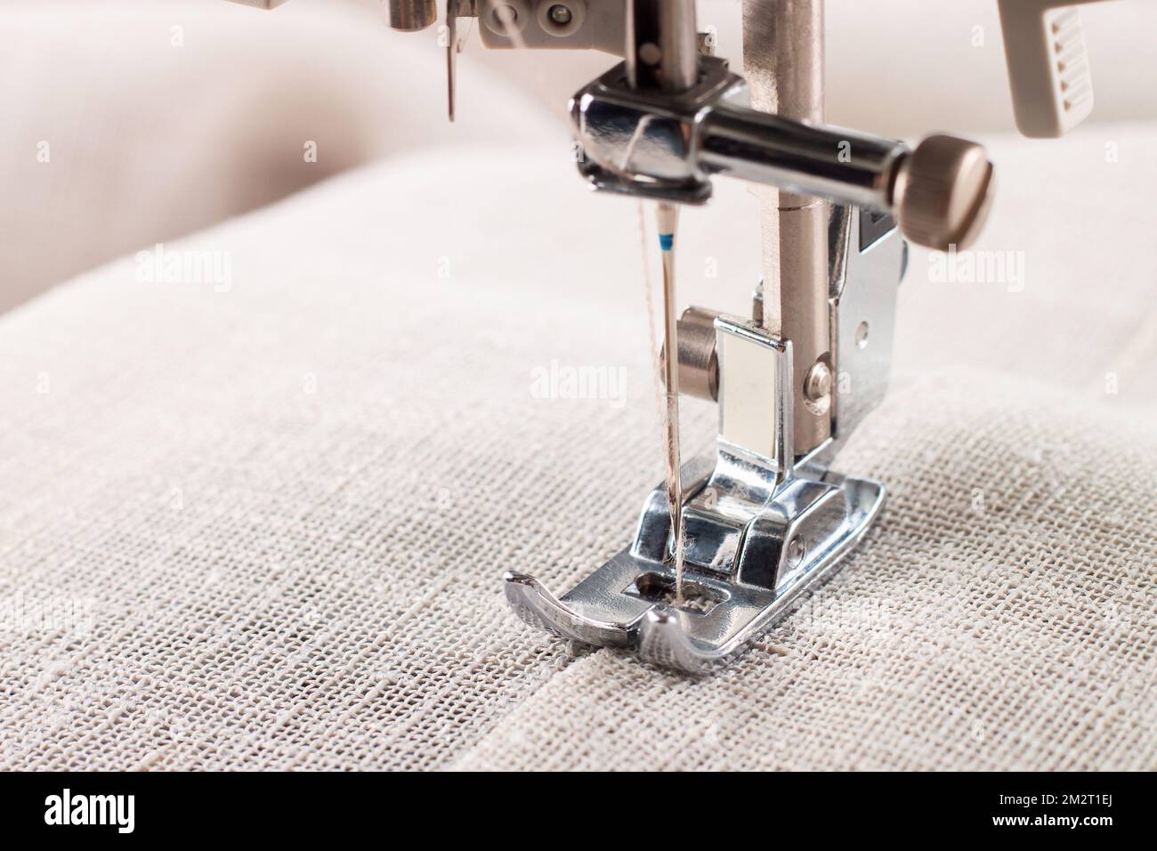 Close-up of modern sewing machine presser foot and needle sewing item ...