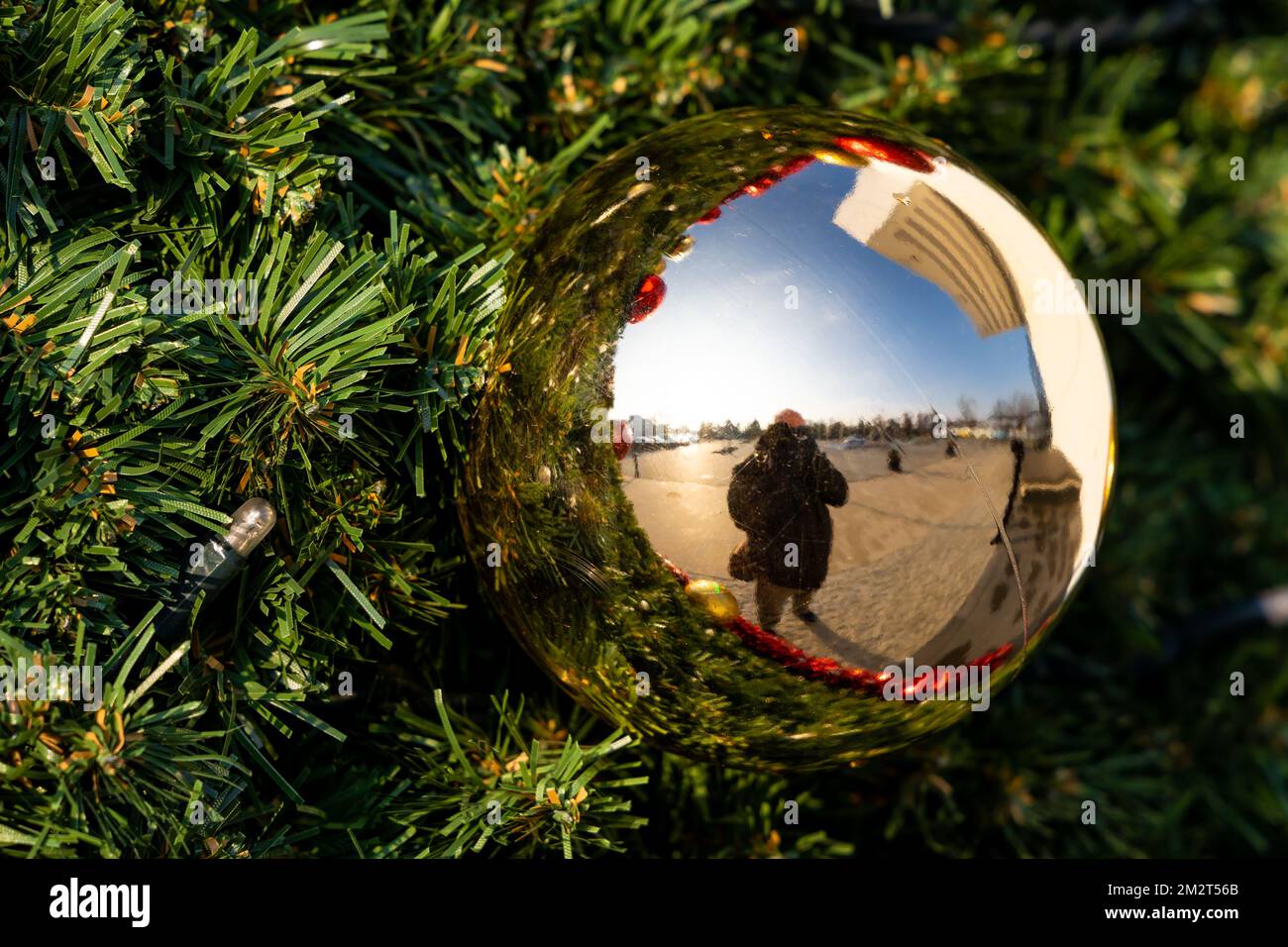 Reflection of a photographer taking a photo in a Christmas ball hanged ...