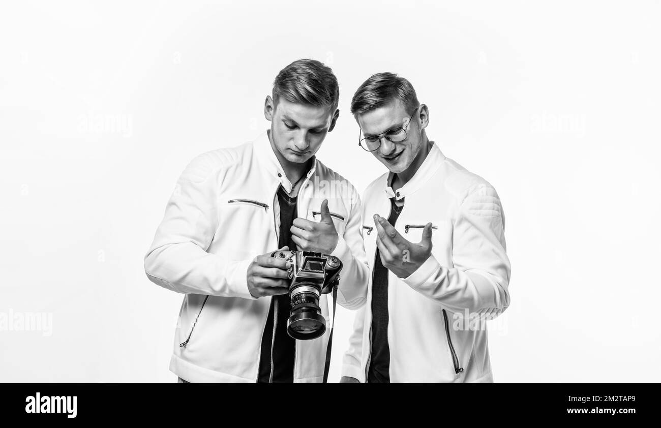 twin brothers men look alike use vintage photo camera, photographing ...