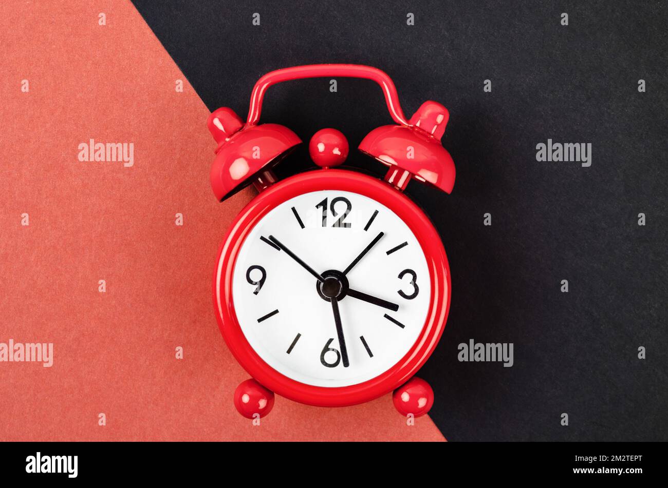 Red vintage alarm clock on red and black colour background Stock Photo ...