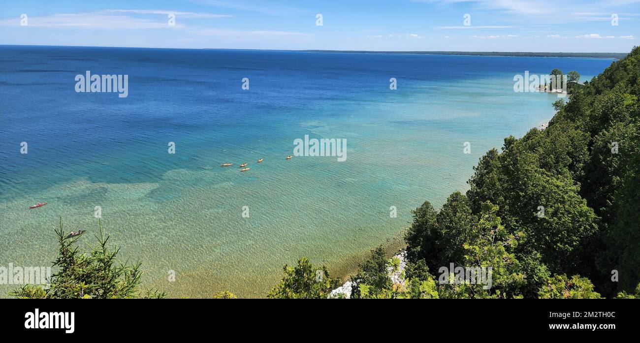 The shore of Lake Huron with a cloudy blue sky in the background in ...