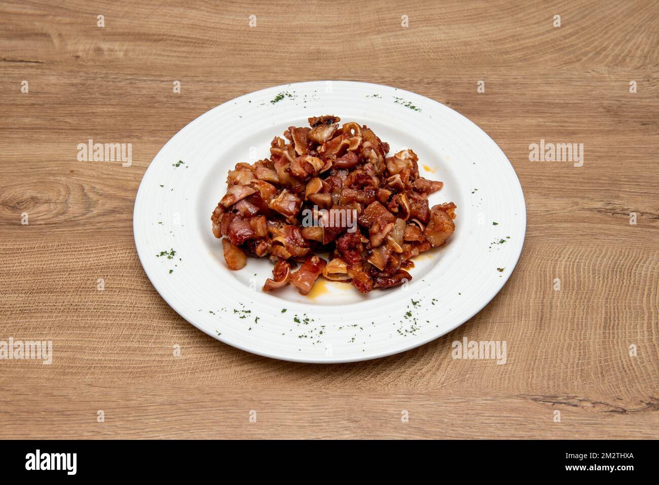 A typical tapa from Spanish bars with grilled ear with dipping sauce on ...