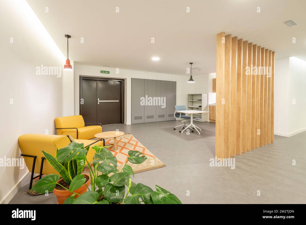 Entrance hall and waiting room of an office with plants and a lattice ...