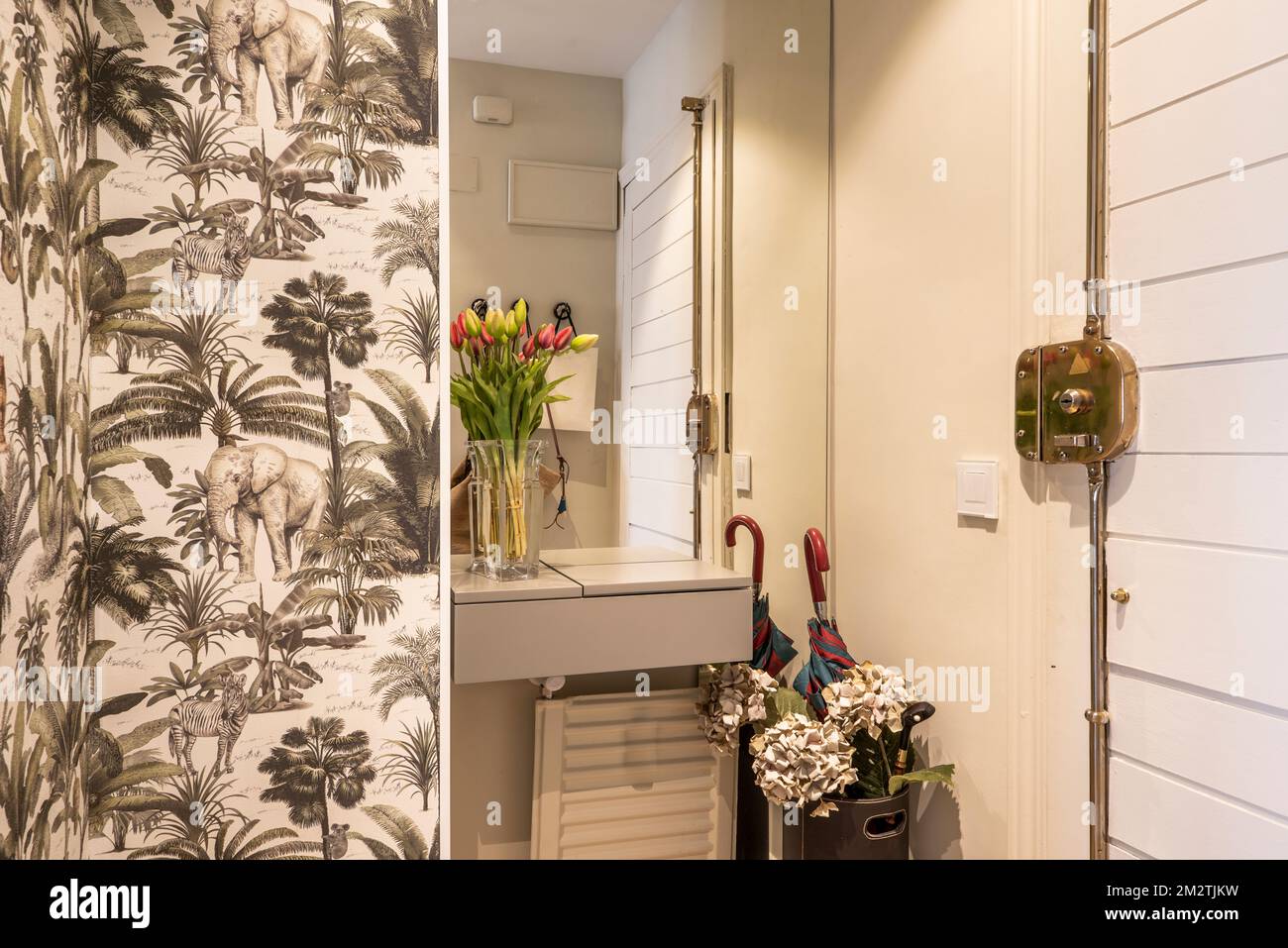 Small hall of a house with a mirror on the wall, decorative wallpaper ...