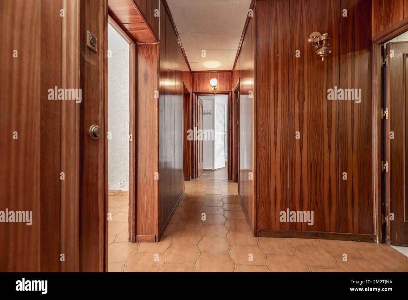 lobby of a house with all the walls covered in wood, access to several ...