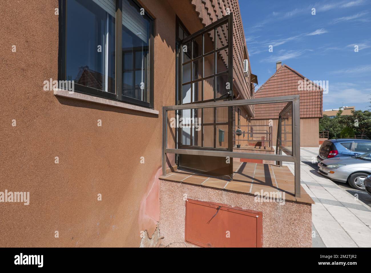 Exterior hall of a house with brown walls and clay tiles on the facade ...