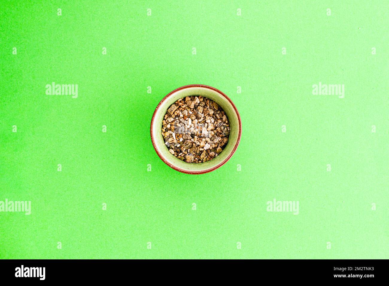 A top view image with soil of smell on green surface Stock Photo - Alamy