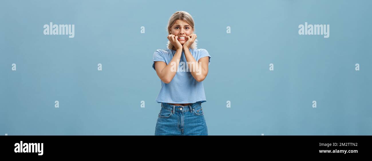 Attractive adult girl scared dad knows her secret standing over blue ...