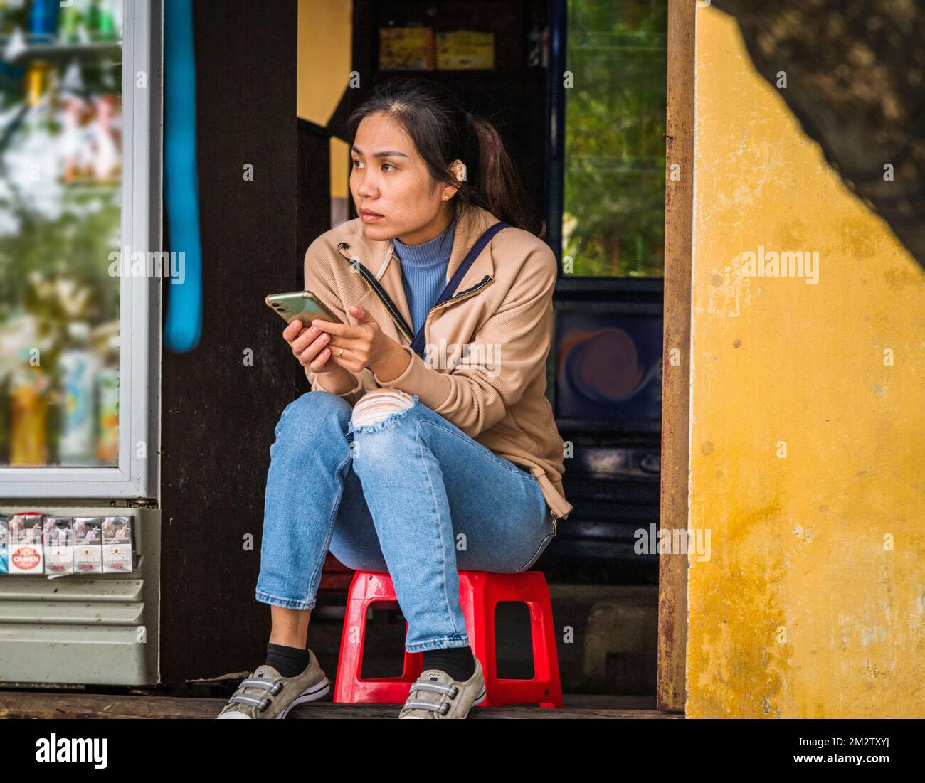 Smart woman sitting on stool hi-res stock photography and images - Alamy