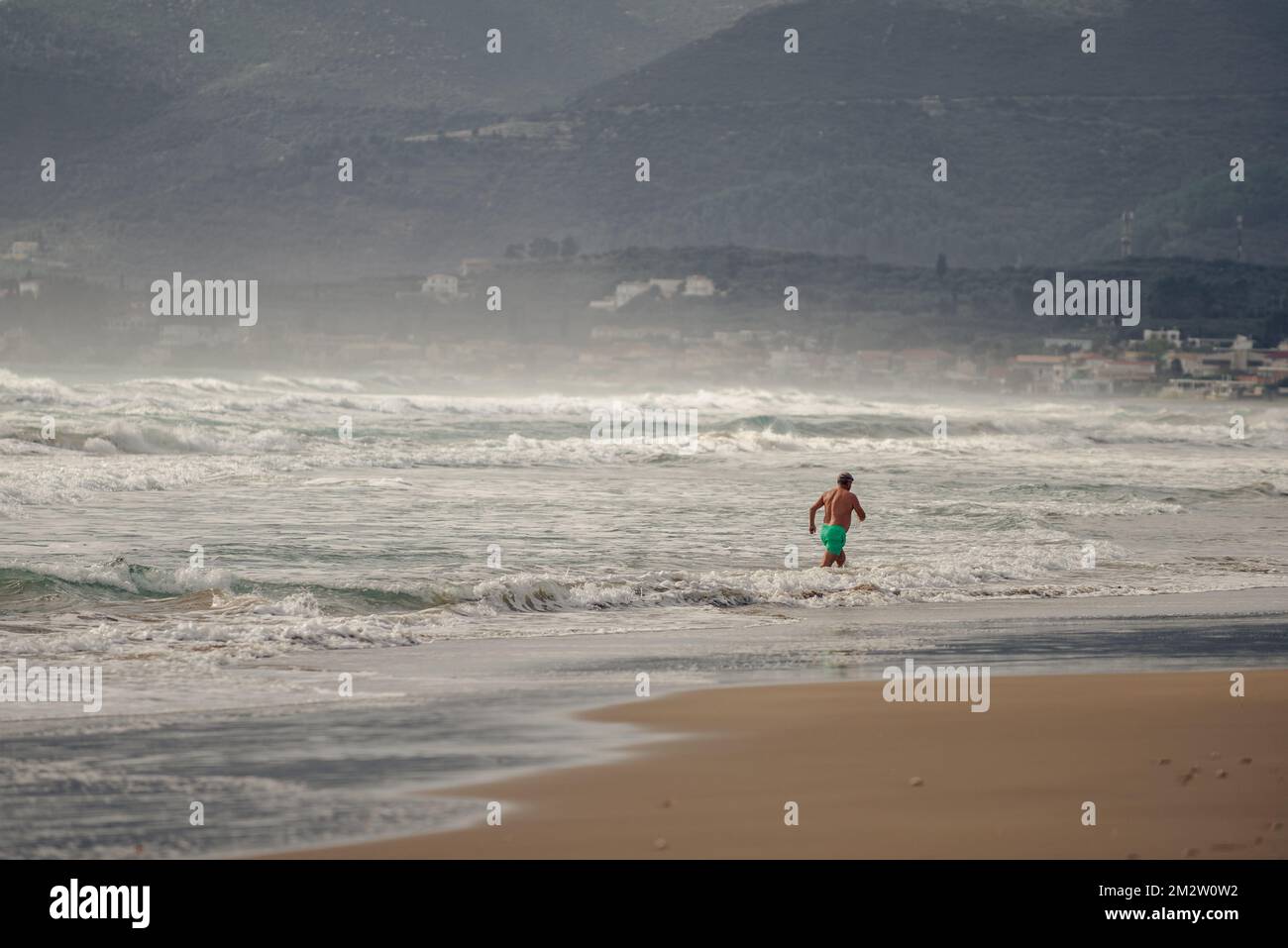 A man in the waves at the beach Stock Photo - Alamy