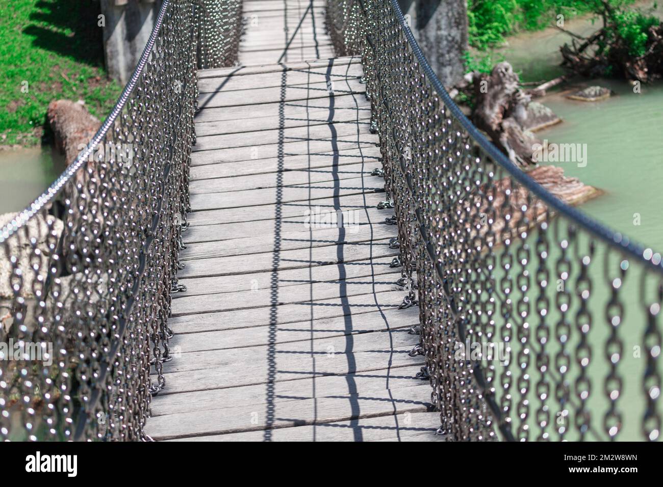 Footbridge over the river . Pedestrian bridge made by chains and wooden ...