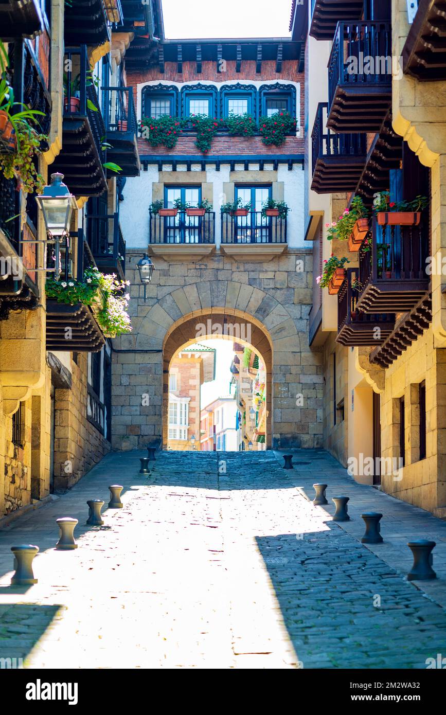 View of a street with a city gate Stock Photo - Alamy