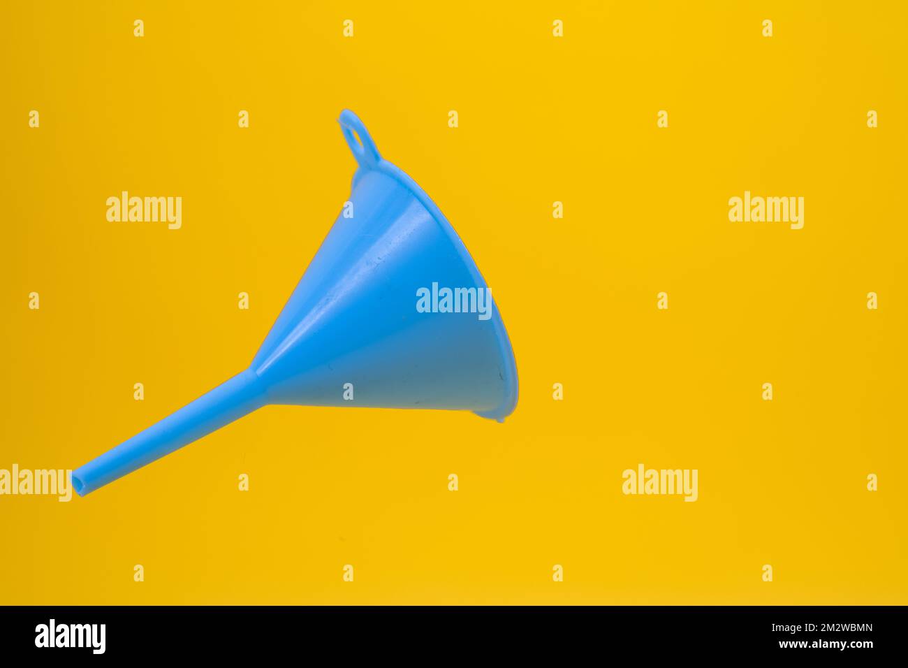 close up of blue plastic funnel isloated on a yellow background Stock ...