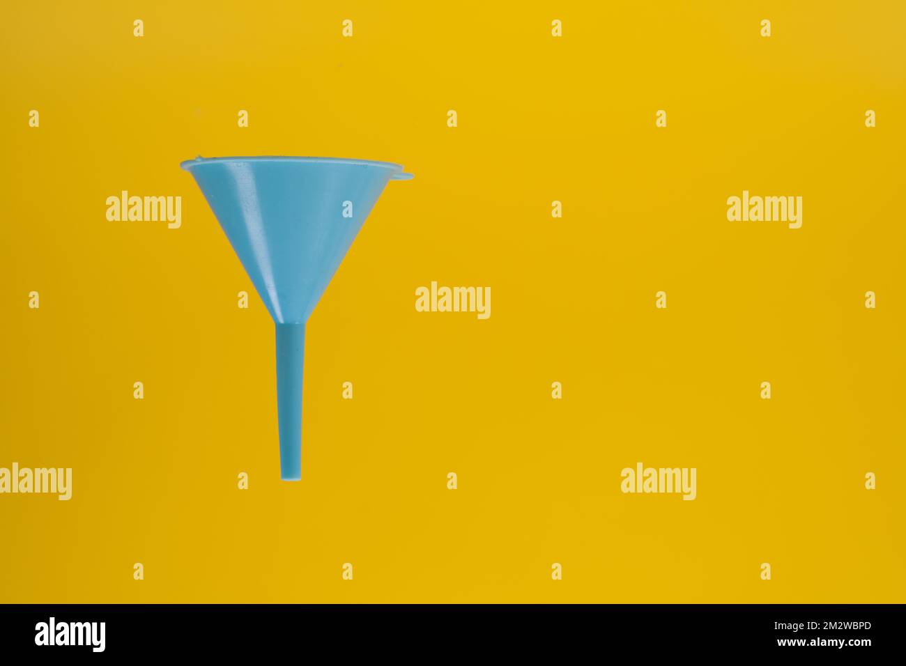 close up landscape orientation of blue plastic kitchen funnel isloated ...